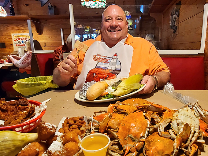 A happy diner sporting the universal uniform of serious crab eaters: the bib. When the food requires protective gear, you know it's going to be good.