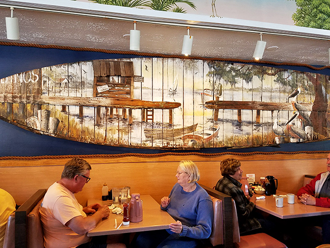 The weathered boat art watches over diners like a breakfast guardian angel. Some conversations are simply better had over pancakes.