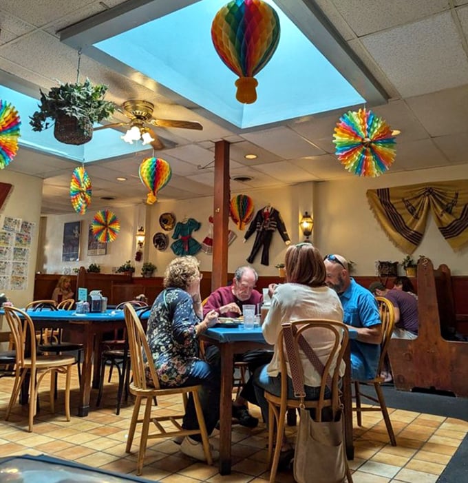 Colorful paper decorations dance above diners deep in breakfast bliss. The universal language of "mmm" needs no translation here.