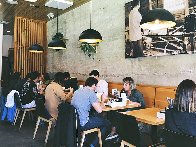 The lunch crowd settles in beneath those gorgeous pendant lights, everyone focused on their delicious missions.