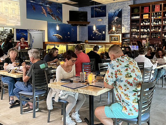 The dining room buzzes with the universal language of seafood appreciation. Notice how nobody's looking at their phones? That's the power of properly prepared ocean fare.