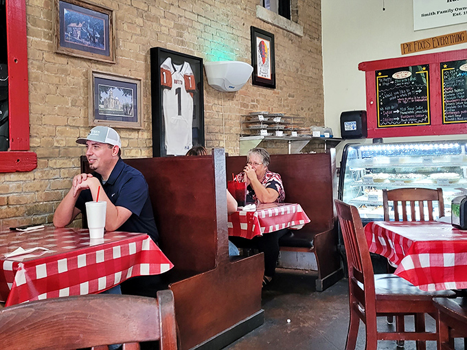 The dining room buzzes with conversation and laughter against exposed brick walls&mdash;a community gathering place where food brings strangers together.