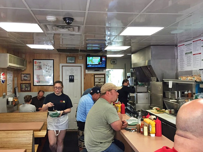 A bustling lunchtime scene where strangers become temporary family. Everyone united by the universal language of "mmm, that's good."