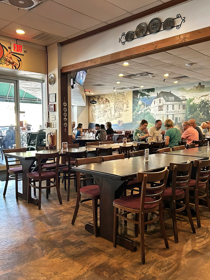 Rustic wooden tables, German murals, and the promise of hearty meals create an atmosphere of Alpine hospitality.