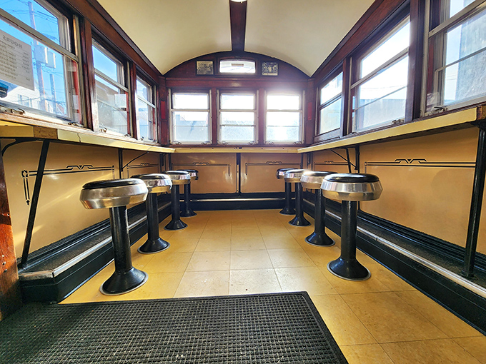 The diner's interior is a masterclass in efficient design, where every stool is a front-row seat to culinary theater.
