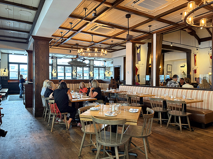 Diners enjoying harbor views and excellent food, living their best coastal life while you're reading about it like a chump.