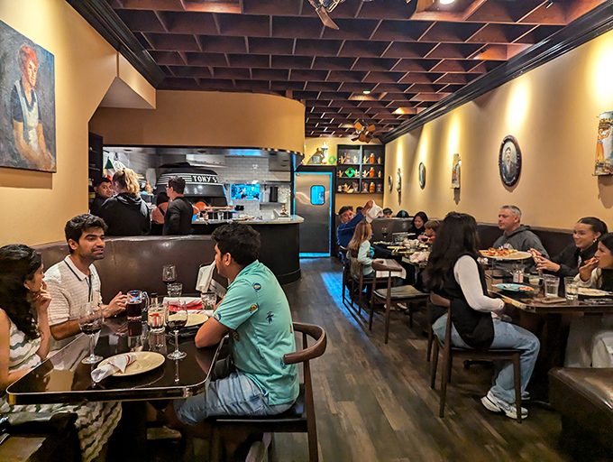 The dining room hums with the universal language of pizza appreciation, where every table is the best seat in the house.