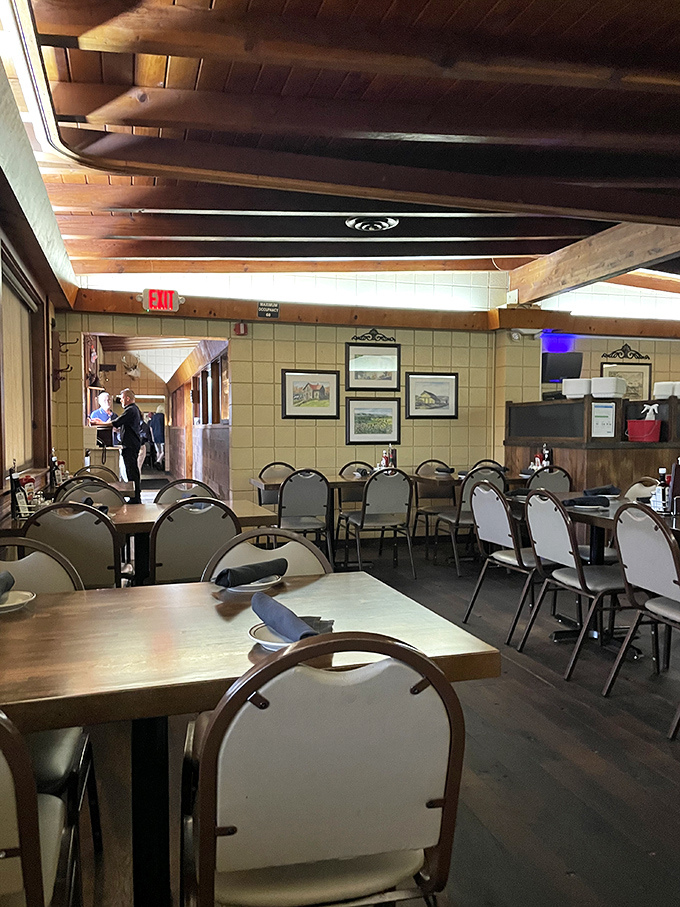 Wood-paneled walls, exposed beams, and tables set for hungry patrons. The dining room has the honest charm of a place that knows exactly what it is.