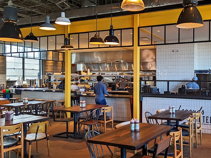 The open kitchen design isn't just trendy&mdash;it's a stage where barbecue becomes performance art, with yellow accents as bright as the flavors.