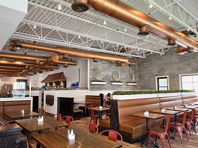 Copper ductwork overhead and leather booths below create an industrial-chic vibe that says, "Yes, we take breakfast seriously, but we're not stuffy about it."