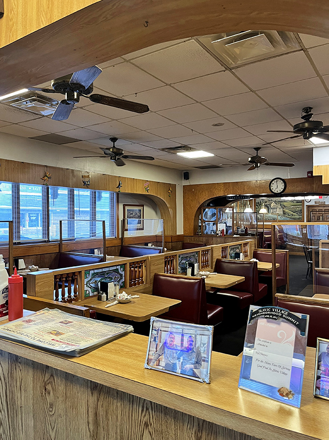 The dining room's ceiling fans lazily spin above wood-paneled dividers and burgundy booths where countless Cleveland stories have been shared over coffee.