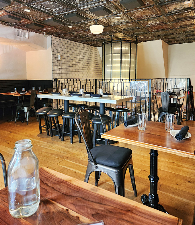 Vintage tin ceiling, industrial lighting, and comfortable seating create the perfect atmosphere for the serious business of enjoying exceptional food.