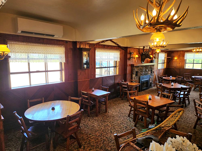 Antler chandeliers cast a golden glow over wooden tables where memories are made between bites of Upper Peninsula excellence.