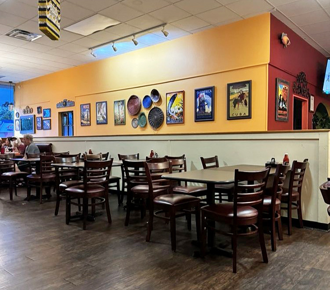 The dining area's vibrant walls showcase Cuban travel posters that transport you faster than any airline ever could.