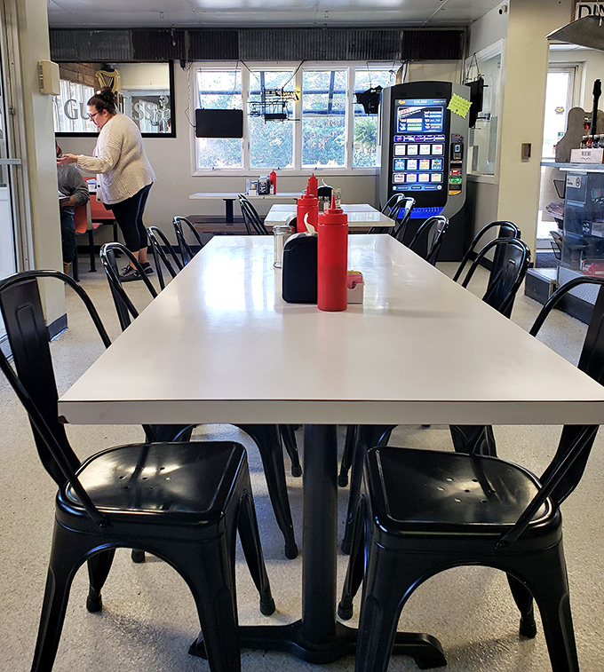 Modern industrial chairs meet classic diner tables in a space where conversations flow as freely as the coffee. Democracy in dining room form.