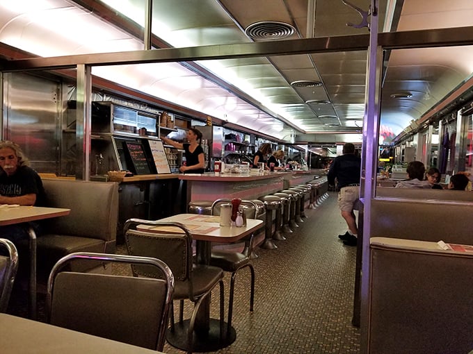 The diner's interior stretches like a silver bullet of comfort. Where strangers become regulars and regulars become family over bottomless cups of coffee.