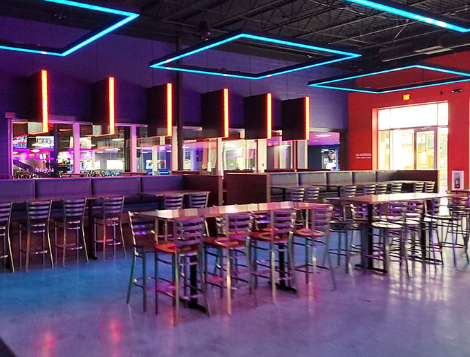 Neon-lit dining area where racing stories grow taller with each bite and sip. "I was THIS close to the track record!"