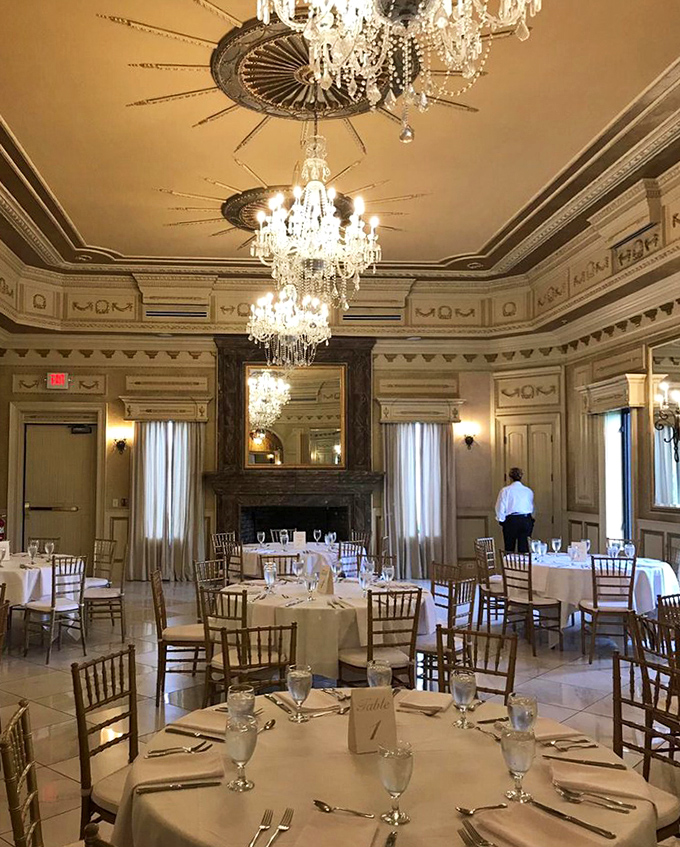 Inside the dining room, crystal chandeliers cast a warm glow over tables set for a feast worthy of King Arthur's court.