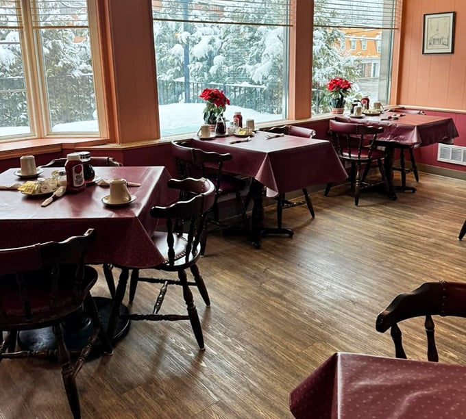 The spacious dining room with tablecloths and large windows offers a refined atmosphere perfect for lingering over your morning meal.