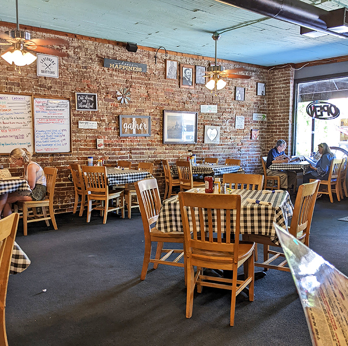 The dining area's exposed brick walls and checkered tablecloths create an atmosphere where strangers become friends and good food becomes great through shared experience.