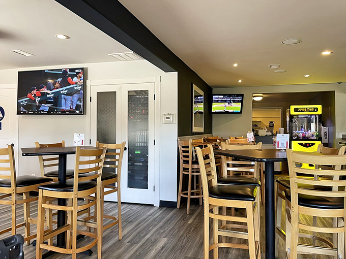 High-top tables and TVs create that perfect "neighborhood joint" vibe where strangers become friends over shared barbecue enthusiasm.