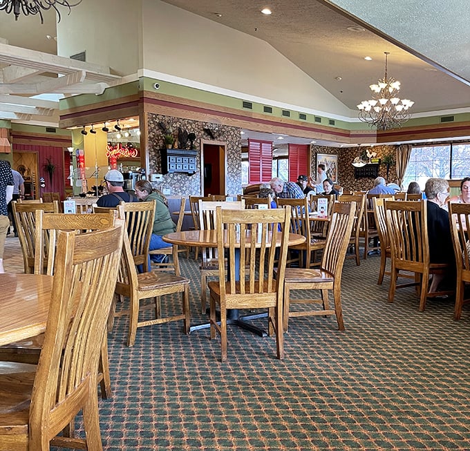 The dining room hums with conversation and satisfaction&mdash;wooden chairs, patterned carpet, and chandeliers creating that perfect "welcome home" atmosphere.