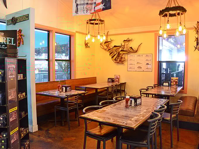 Warm wood tones, fish identification charts, and vintage lighting create a dining room that feels like the captain's quarters of a particularly delicious ship.