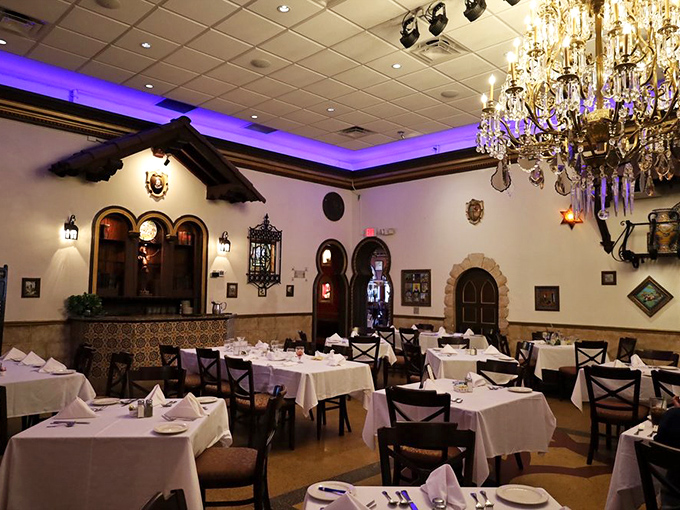 Purple lighting transforms this dining room into something between a Spanish cathedral and your coolest friend's dinner party.