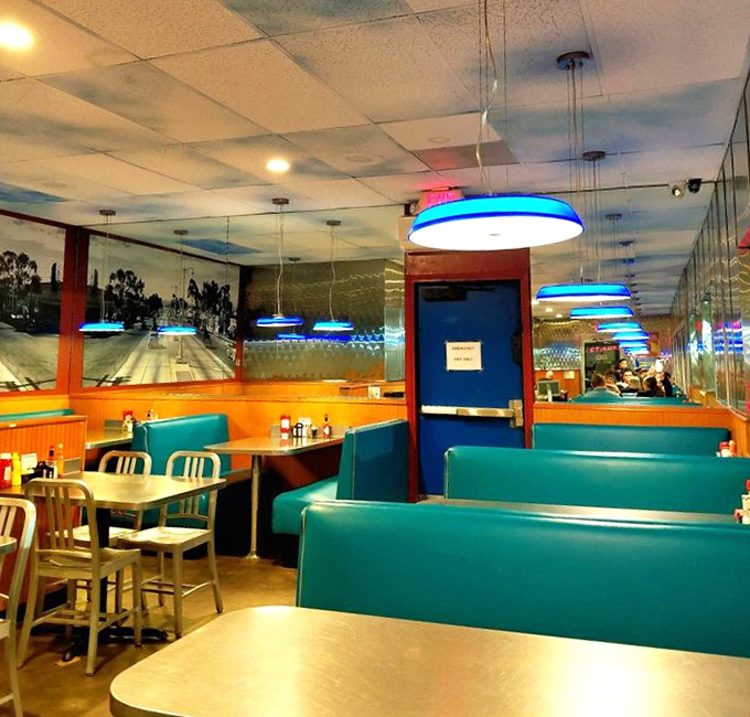 The dining area glows with blue light like an underwater diner where comfort food is the sunken treasure everyone's diving for.