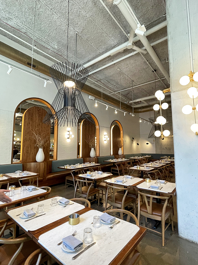 The dining room feels like the living room of that impossibly stylish friend who makes everything look effortless—those pendant lights could star in their own design magazine.