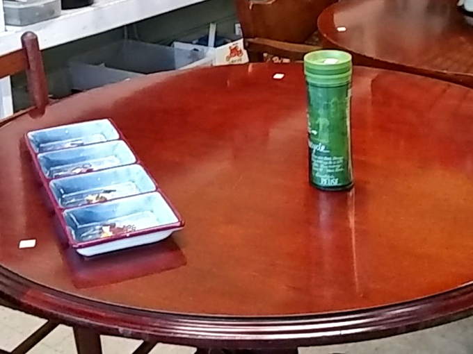 A polished wooden table displaying small treasures &ndash; the kind of solid craftsmanship that makes you wonder about the family dinners it once hosted.