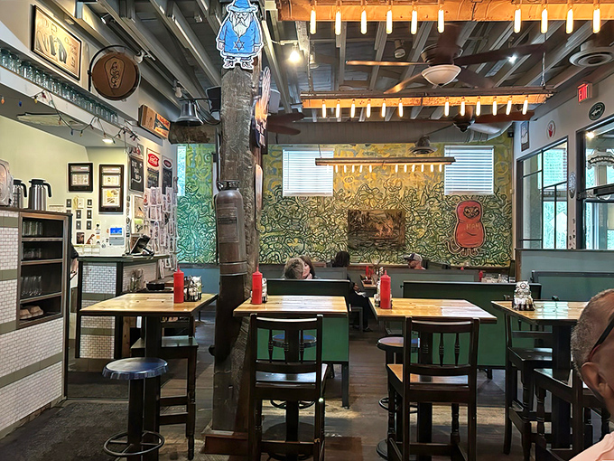 Vintage chairs and eclectic artwork create spaces where strangers become friends over shared appreciation for exceptional food.