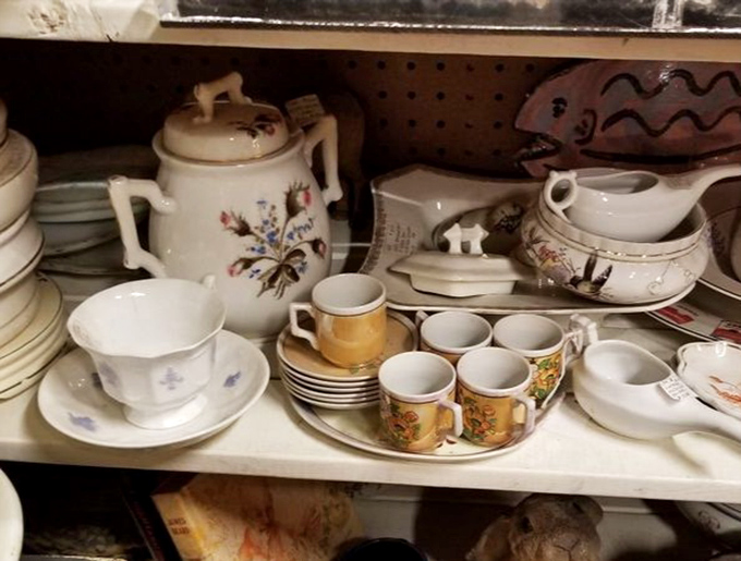 Delicate teacups and saucers arranged like a forgotten formal dinner party, waiting for someone to bring them back to Sunday service.