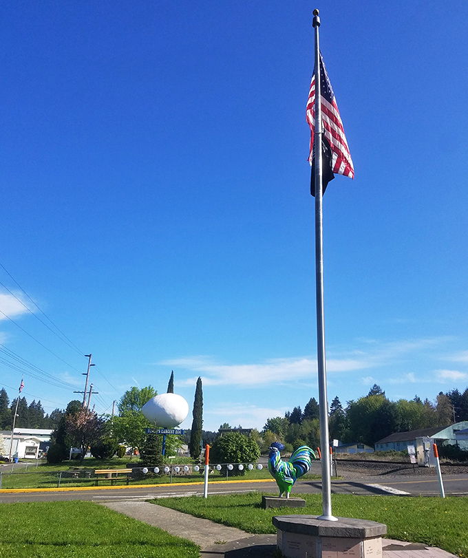 Old Glory waves above the egg monument and a colorful rooster, creating perhaps the most patriotic poultry display in America.