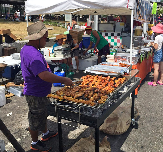 The universal language of grilled meat speaks volumes at the beach festival, where smoke signals summon hungry beachgoers from miles away.