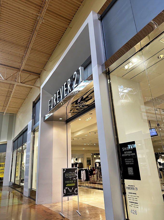 Forever 21 beckons with its minimalist entrance, promising clothes that make you feel young even if your knees make different noises than they did at 21.