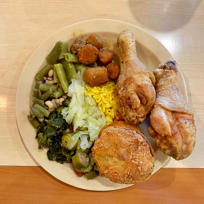 A plate that tells the story of the South: fried chicken, collard greens, cornbread, and enough sides to make decision-making the hardest part of your meal.