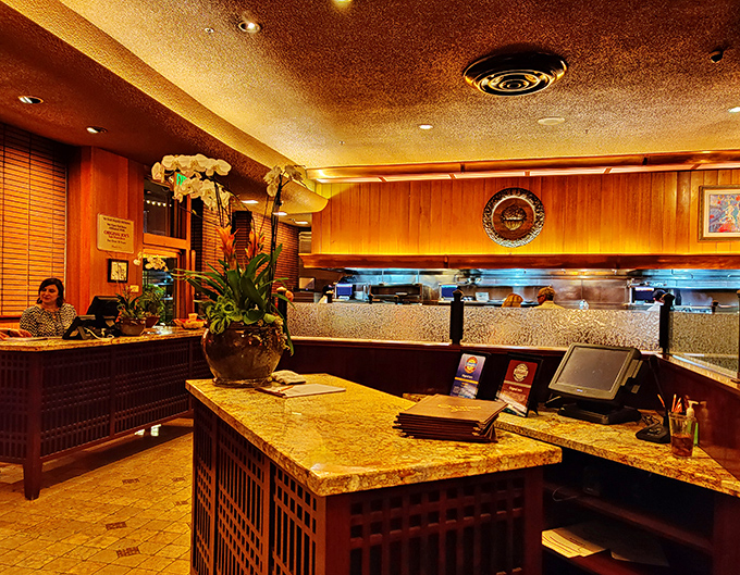 The host station isn't just where you check in&mdash;it's the gateway to an evening where marble countertops and warm wood paneling set the stage.