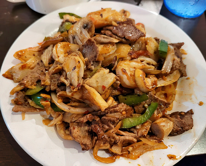 A plate of hibachi-grilled perfection featuring beef, shrimp and vegetables that didn't know they could get along so beautifully.