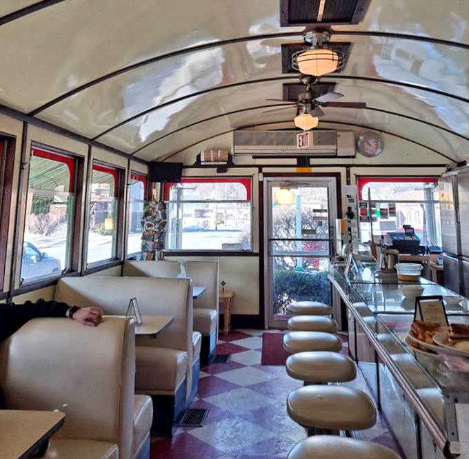The diner's interior stretches like a railroad car of culinary dreams, where every booth tells stories and every counter seat offers front-row views.