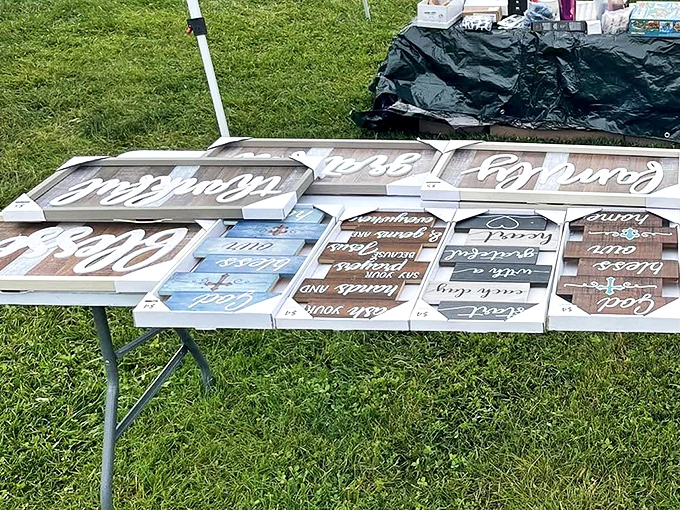 Words to live by, displayed on rustic wood. Someone's Pinterest board has escaped into the wild and landed on this vendor's table.