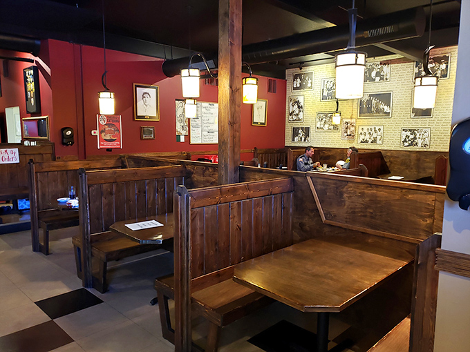 Wooden booths create intimate dining spaces where conversations flow as freely as the wine. These tables have heard decades of first dates and family celebrations.