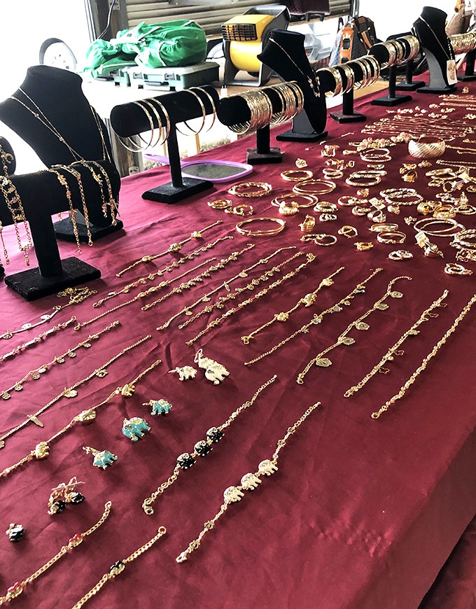 Glittering possibilities spread across crimson velvet. Each bracelet and necklace waits patiently for the right wrist or neck to call home.