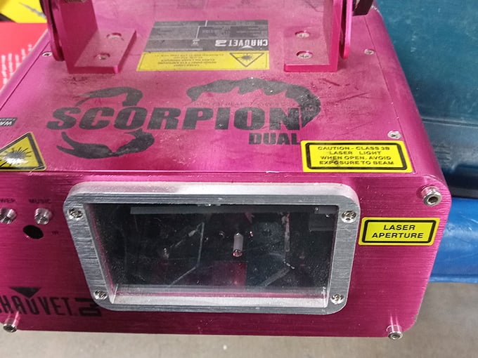 A professional DJ light system nestled between household castoffs. Someone's abandoned nightclub dreams could become your next backyard party's secret weapon.