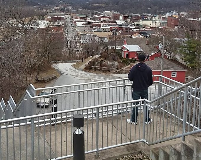 A visitor contemplates the panoramic view that inspired America's greatest storyteller, proving some vistas never lose their magic.