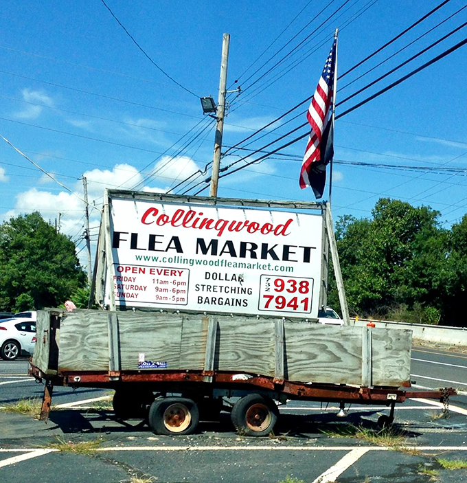 The sign says it all! Collingwood's roadside welcome promises "dollar stretching bargains" beneath a proudly waving flag—Americana at its most authentic.