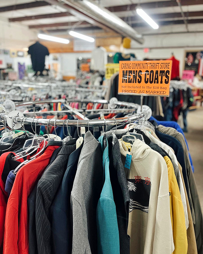 Men's coats lined up like hopeful actors at a Branson audition. Each one ready for its second act in someone's wardrobe.