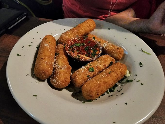 Golden-fried mozzarella sticks with marinara for dipping. Crispy on the outside, stretchy cheese pull on the inside &ndash; life's simple pleasures.