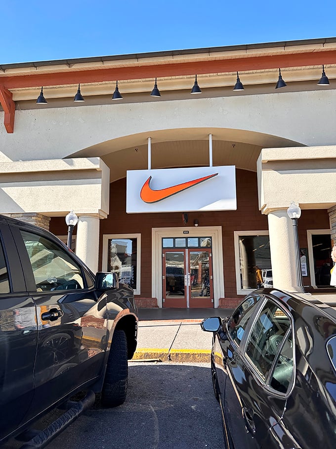 The swoosh beckons like a retail siren song. Nike's storefront promises athletic glory, even if your only marathon is through the outlet mall.