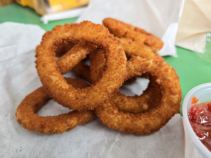 Onion rings with architectural integrity &ndash; crispy enough to snap, tender enough inside to make you close your eyes in appreciation. Ketchup optional but recommended.